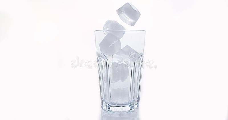 Ice Cubes Falling into Glass Against White Background Stock Image ...
