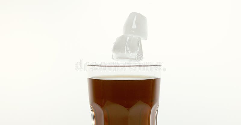 Ice Cubes Falling into Glass of Coke Against White Background Stock ...