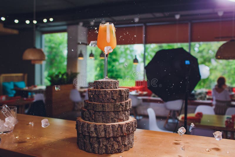 Ice Cubes Falling into a Splashing Orange Cocktail. Stock Image - Image ...