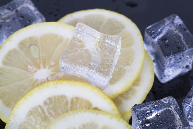 Ice cubes and lemon slices stock photo. Image of drops - 98551786