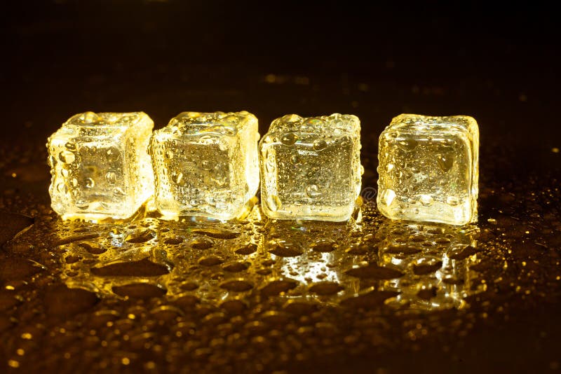Ice Cubes on a Reflections Yellow Light Stock Photo - Image of blocks ...