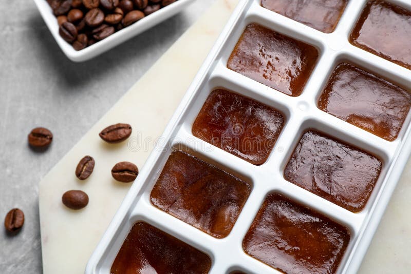 Ice Cubes in Tray and Coffee Beans on Table, Closeup Stock Image ...