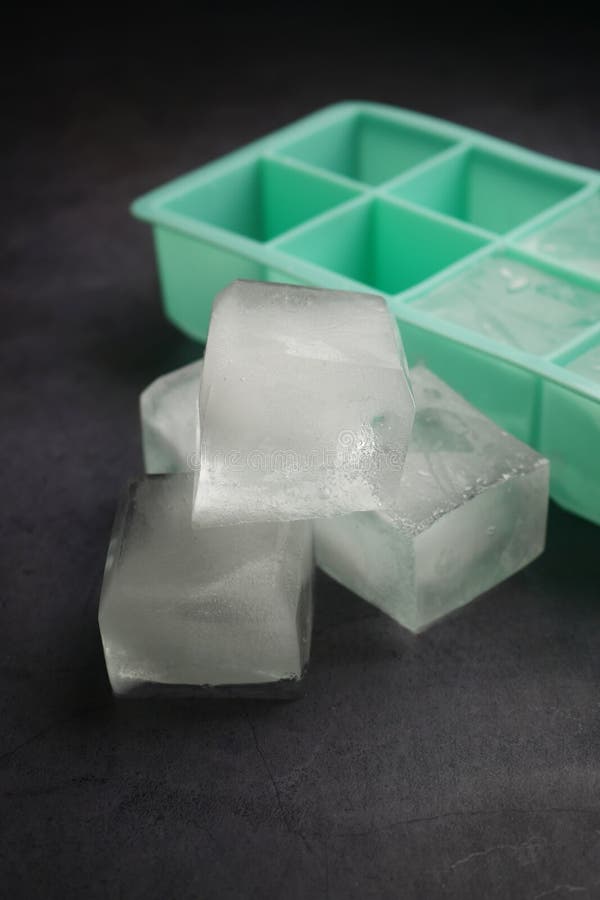 Ice Cubes in Various Sizes beside a Mint Green Ice Tray Stock Photo ...