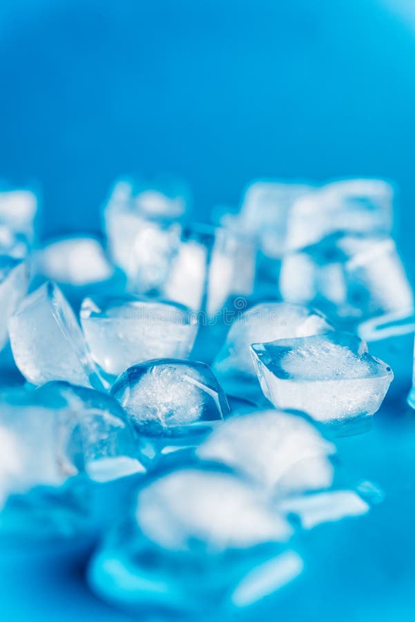 Ice Cubes and Water Drops Scattered on Blue Background Stock Image ...