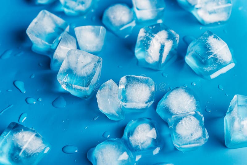 Ice Cubes and Water Drops Scattered on Blue Background Stock Photo ...
