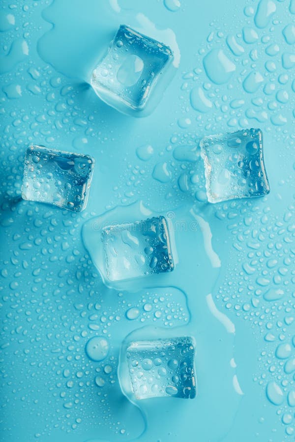 Ice Cube with Water Drops on a Blue Background. the Ice is Melting ...