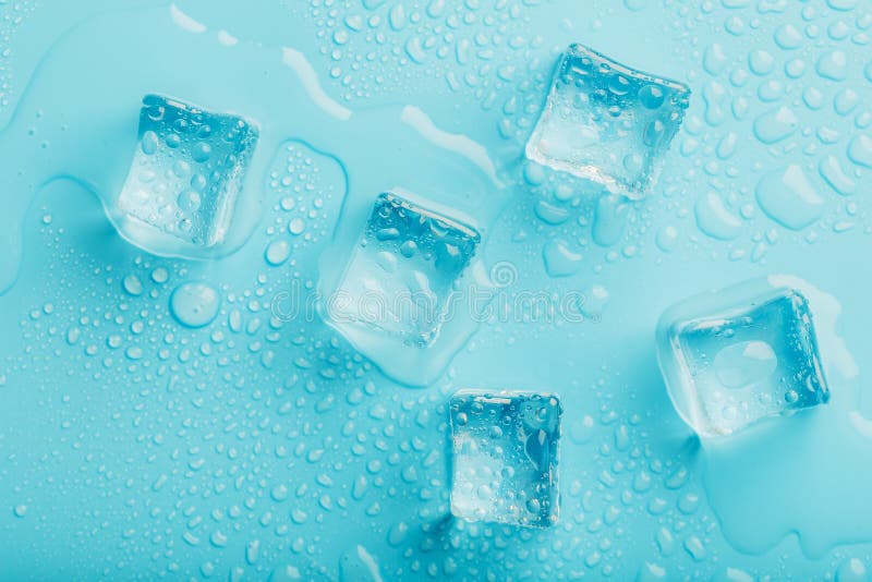 Ice Cube with Water Drops on a Blue Background. the Ice is Melting ...