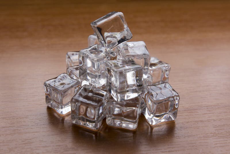 Ice cubes on wooden desk stock image. Image of wood, table - 71398947
