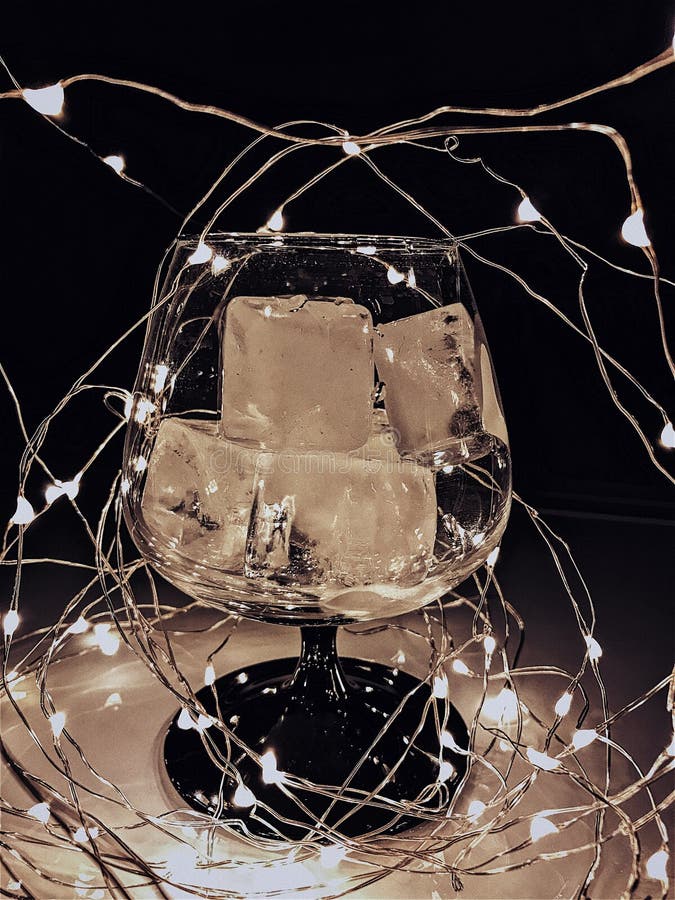 Ice Cubes Wrapped in a Garland of Lanterns Stock Photo - Image of black ...