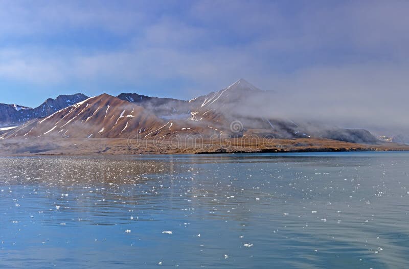 Ice Dotting a Remote Arctic Seascape Stock Photo - Image of clouds ...