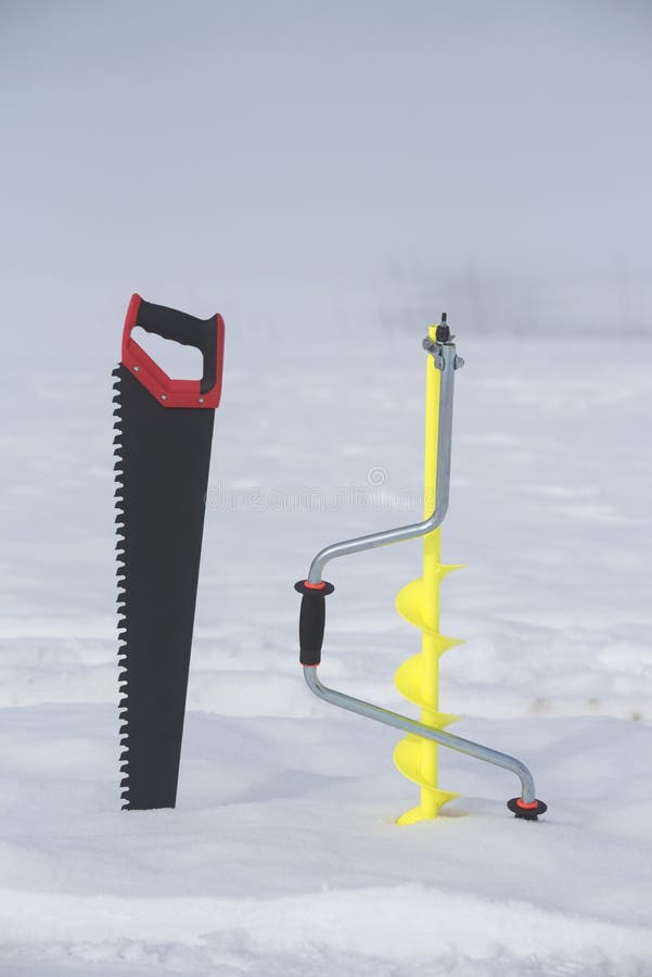 Ice Drill Auger and Saw on a Snow in Sunny Winter Day Stock Image ...