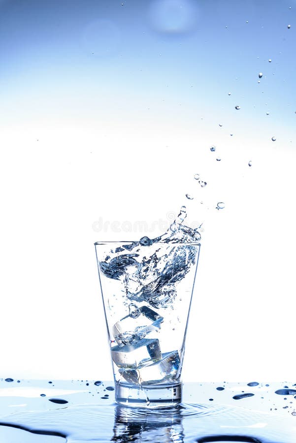 Ice Dropping and Water Splashing in the Glass with Reflection on Stock ...
