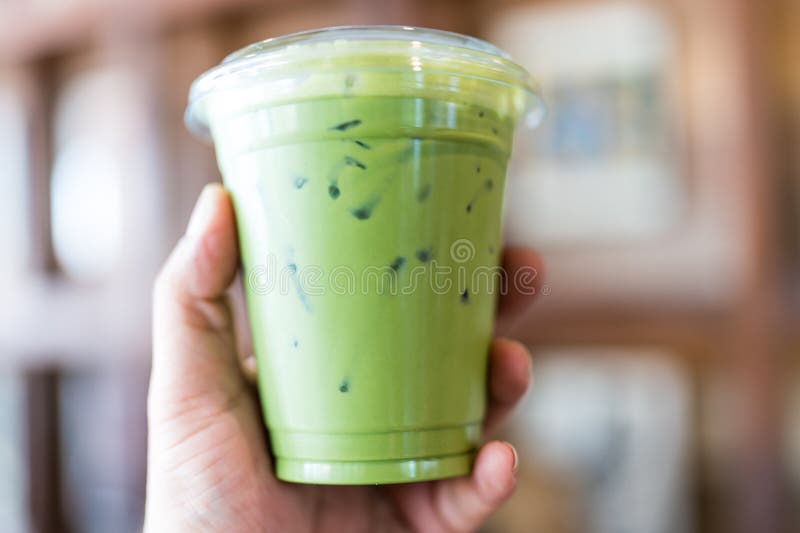 Ice Iced Matcha Latte in Plastic Cup on Hand Stock Photo - Image of ...