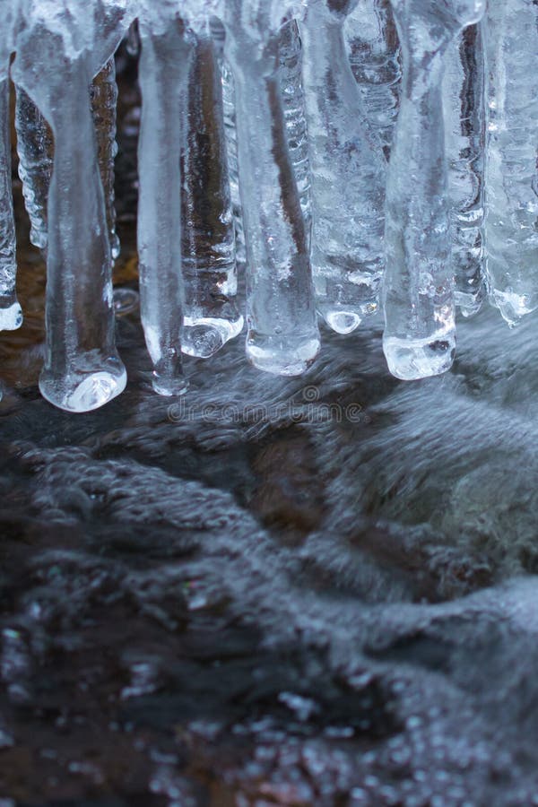 Ice, icicles in water stock photo. Image of crystal - 141962606