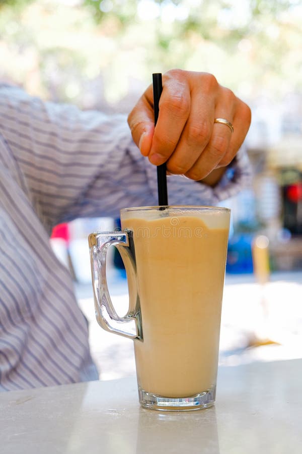 Ice Latte Coffee with a Straw on the Table. Stock Image - Image of ...