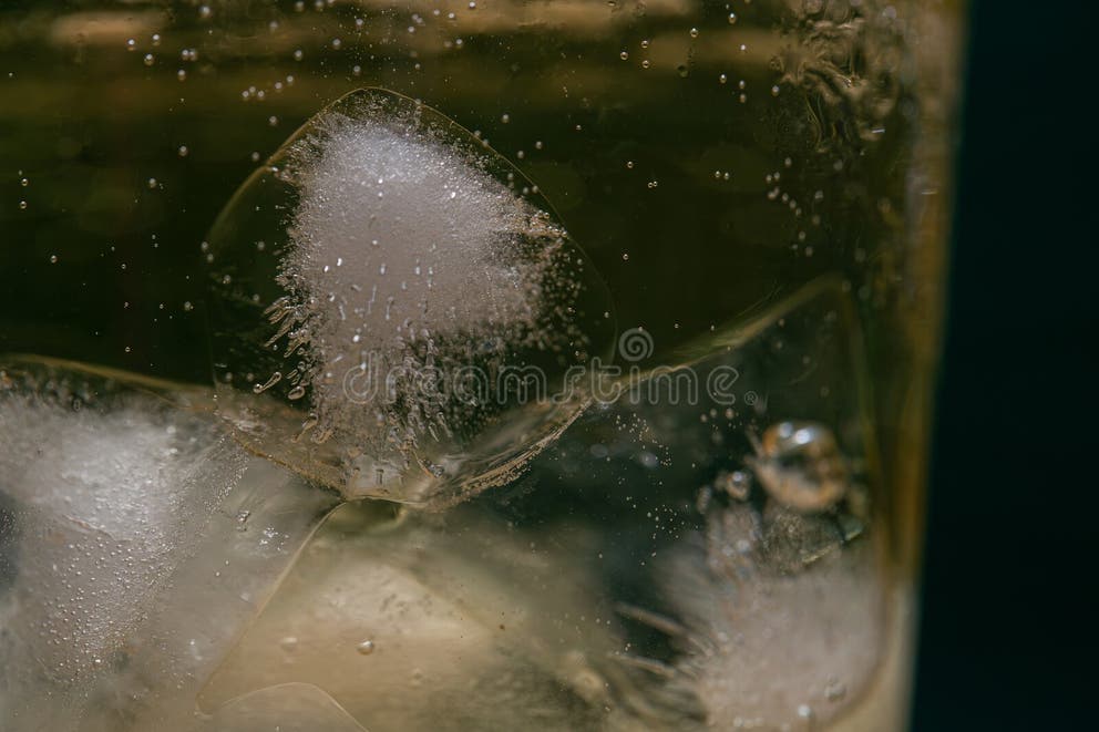 Ice Liquid in the Glass. Ice Cube Stock Photo - Image of brown, brandy ...