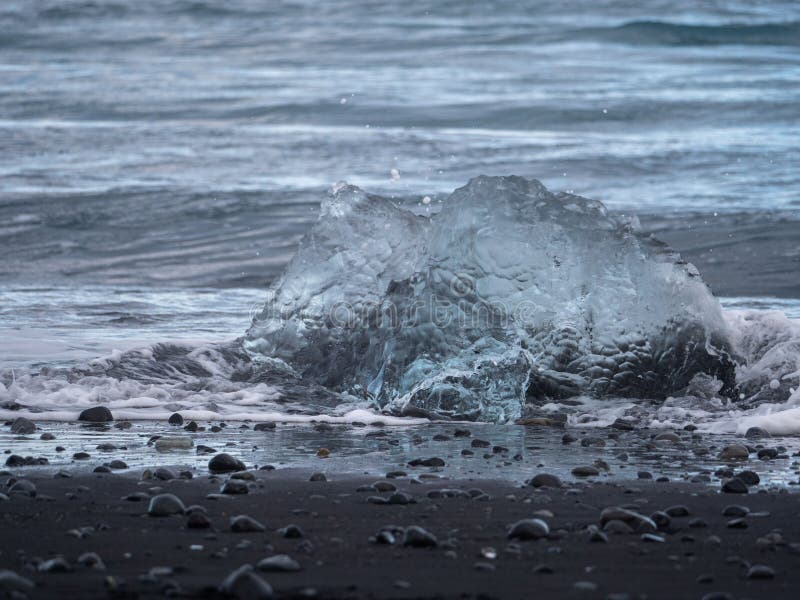 Ice Melting Off a Rock at the Diamond Beach by the Ocean Stock Image ...