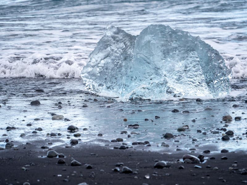 Ice Melting Off a Rock at the Diamond Beach by the Ocean Stock Image ...