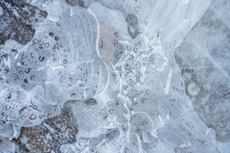 Ice Patterns in a Frozen Puddle Stock Photo - Image of delicate ...