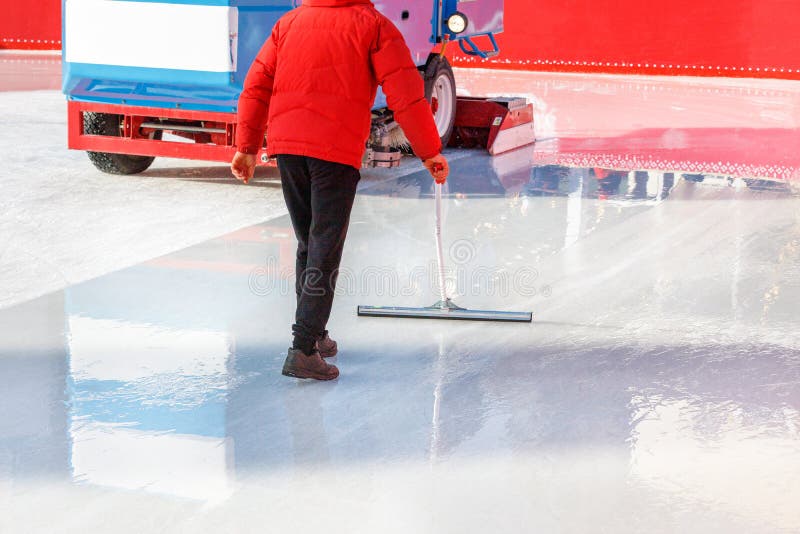 An Ice Rink Worker Cleans and Levels the Ice Surface with a Rubberized ...