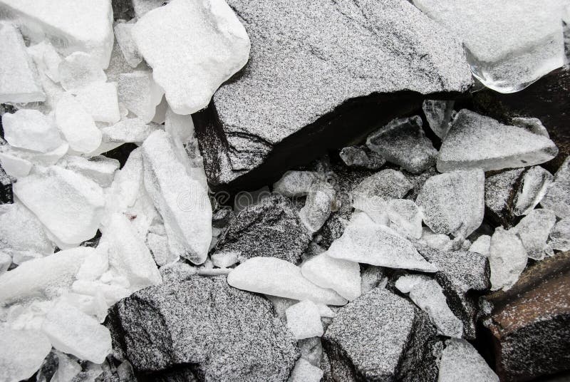 Ice and rocks on the beach stock image. Image of rough - 192270365