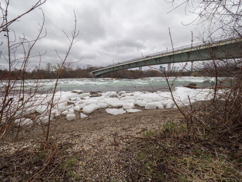 Ice Rocks on the Niagara River Shore, Bridge Over Water Stock Photo ...