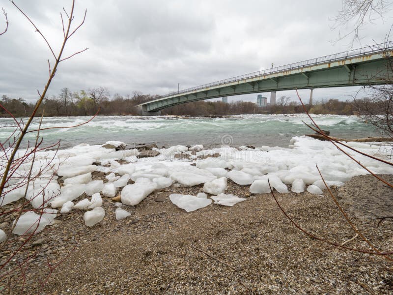 Ice Rocks on the Niagara River Shore, Bridge Over Water Stock Photo ...