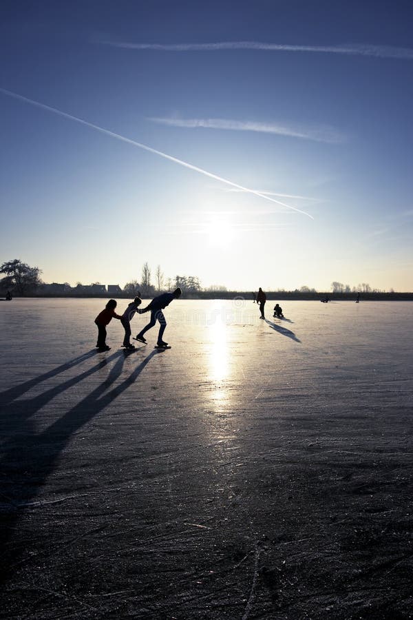 Ice Skating at Sunset in the Netherlands Stock Image - Image of ...