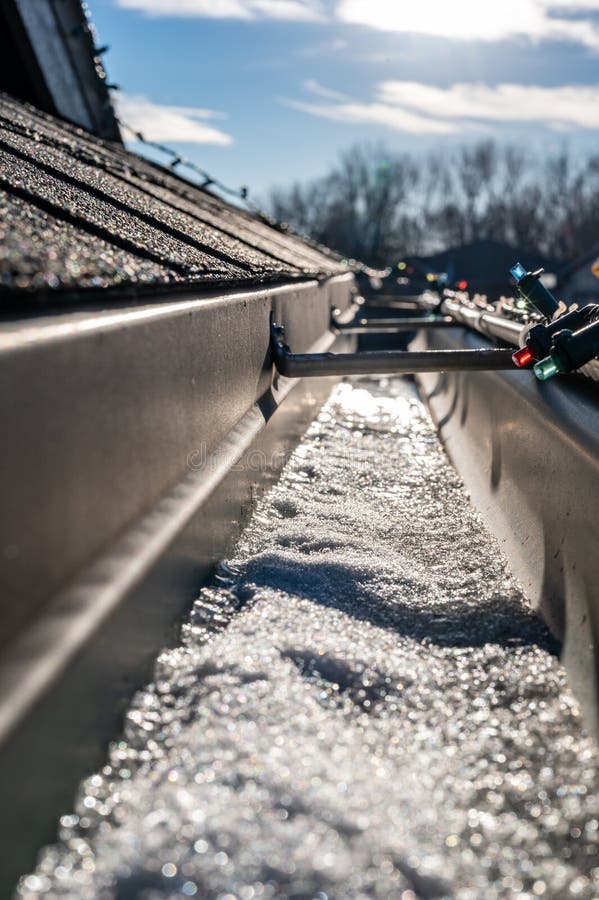 Ice and Snow Building Up Inside a Rooftop Gutter System on a ...