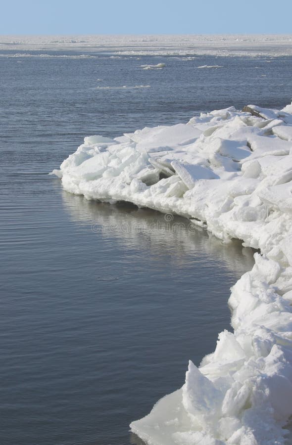 Ice/Snow heap in the sea stock image. Image of water, reflection - 745601