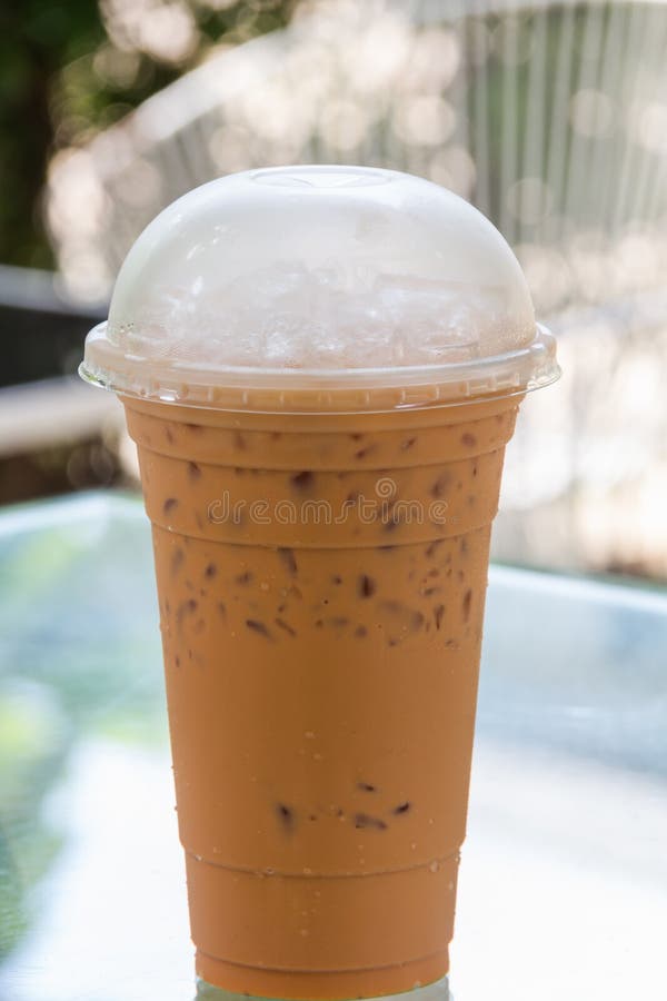 Ice Tea with Milk and Ice Coffee in Plastic Cap on Glass Table Stock ...