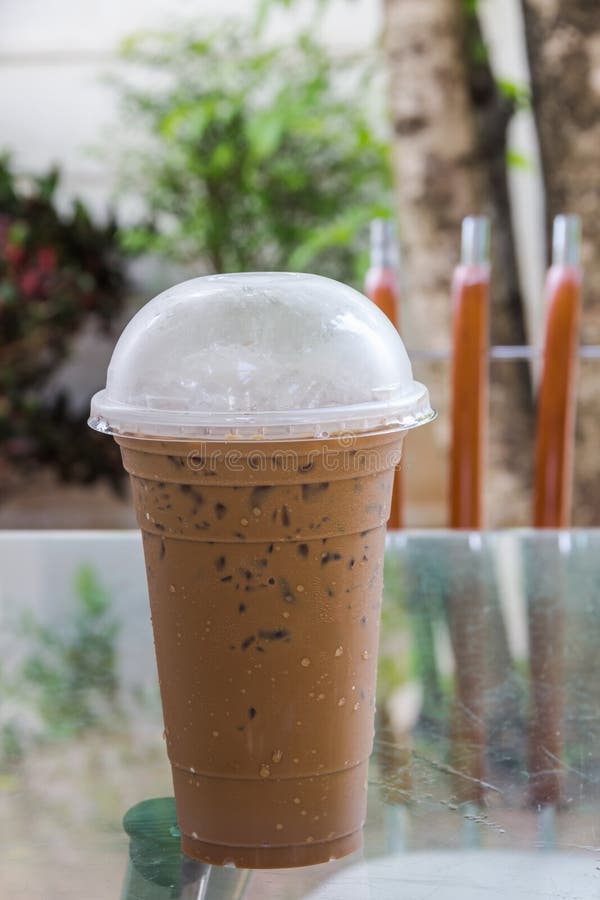 Ice Tea with Milk and Ice Coffee in Plastic Cap on Glass Table Stock ...