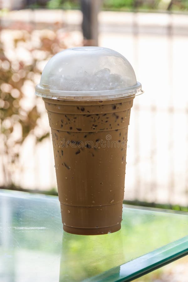 Ice Tea with Milk and Ice Coffee in Plastic Cap on Glass Table Stock ...