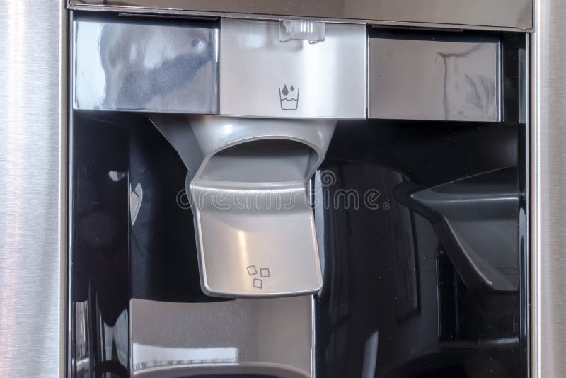 Ice and Water Dispenser on a Refrigerator Inside the Kitchen of a Home ...