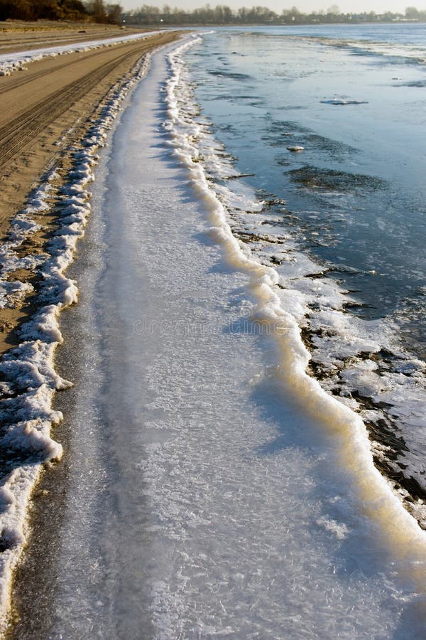 Ice, water and sand. stock image. Image of water, sunny - 65016819