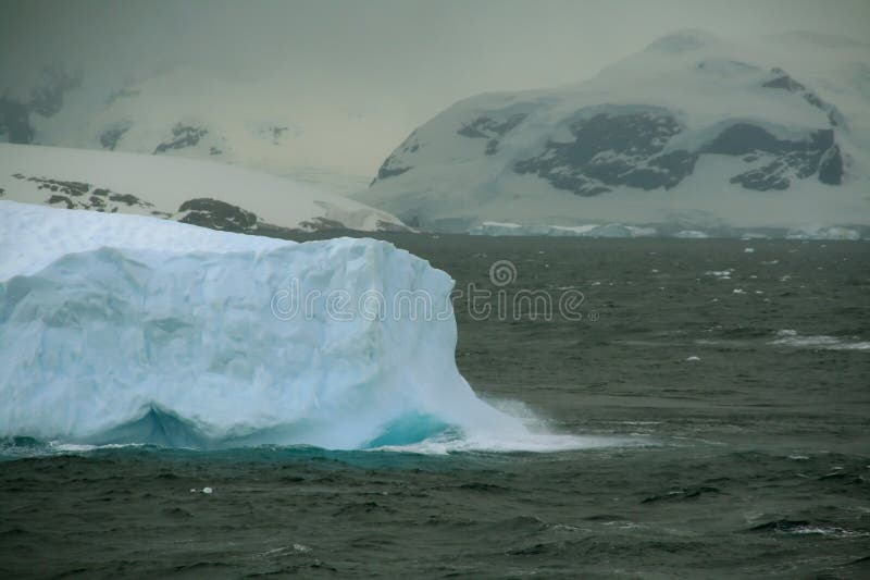 Iceberg Glowing in an Overcast Dawn Stock Photo - Image of ocean, snow ...