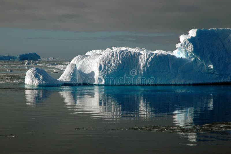 Iceberg In Sunlight With Water Reflection Stock Photo - Image of ...