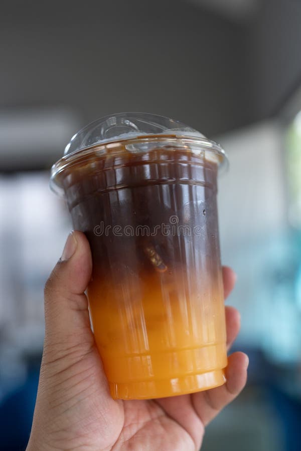 Iced Americano Black Coffee and Layer of Orange Juice Stock Image ...