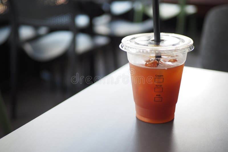 Iced Americano in Plastic Container on Cafe Table Stock Photo - Image ...
