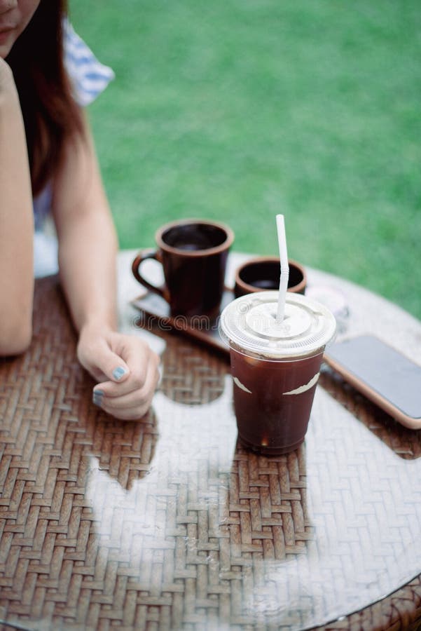 Iced Black Coffee on the Table with a Woman S Hand Placed. Stock Image ...