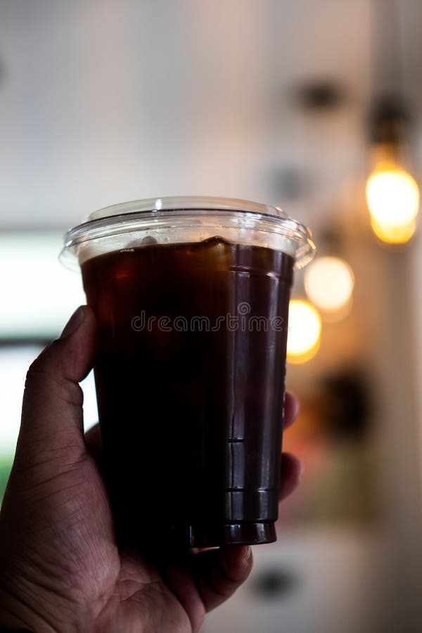 Iced Black Coffee in Take Away Plastic Glass in Hand Stock Image ...