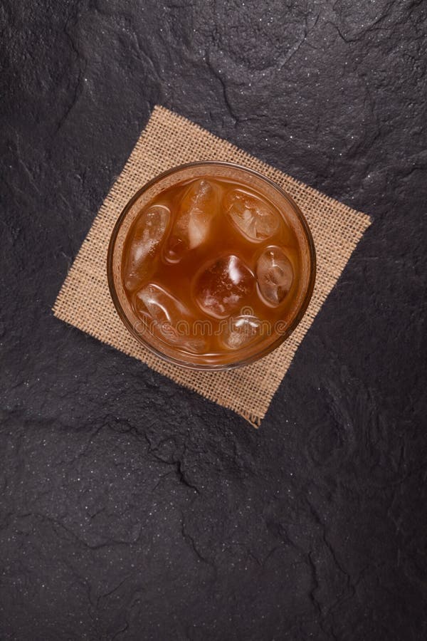 Iced Coffee with Ice in a Transparent Glass on a Dark Stone Surface ...