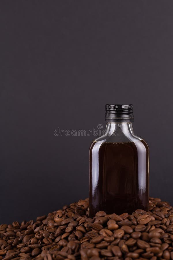 Iced Cold Brew Coffee in Bottle Mockup on a Mountain of Roasted Coffee ...
