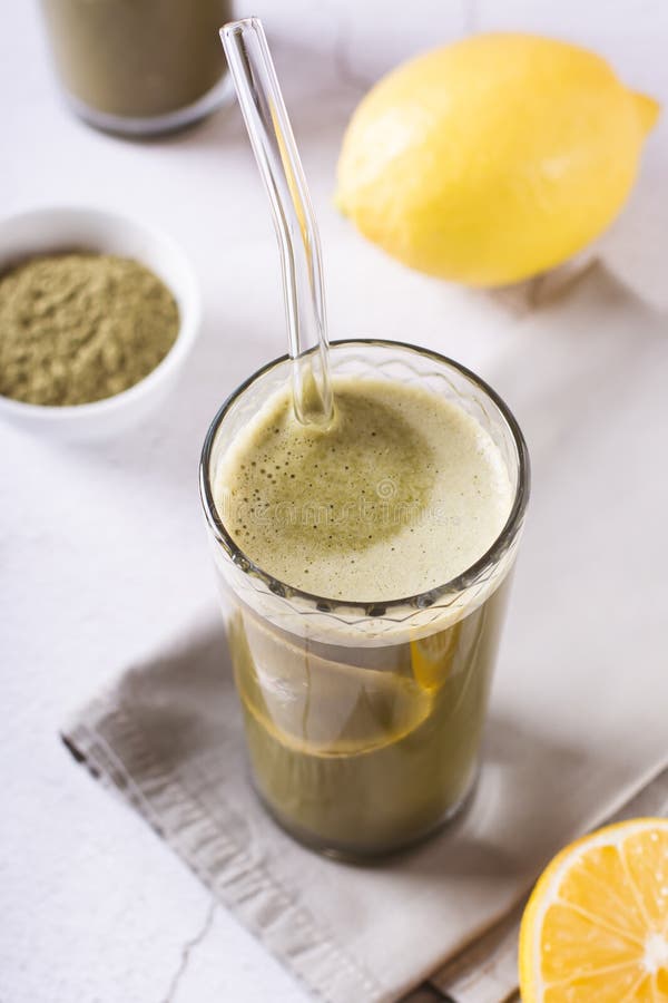 Iced Matcha Lemonade with Lemon in Glasses with Straws on the Table ...
