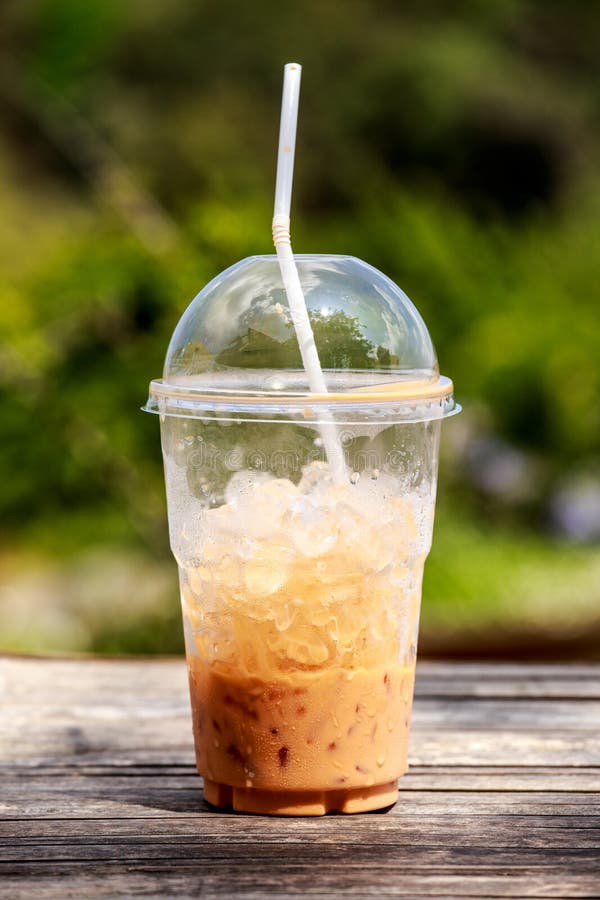 Iced Milk Tea in a Plastic Cup on Wooden Table Stock Image - Image of ...