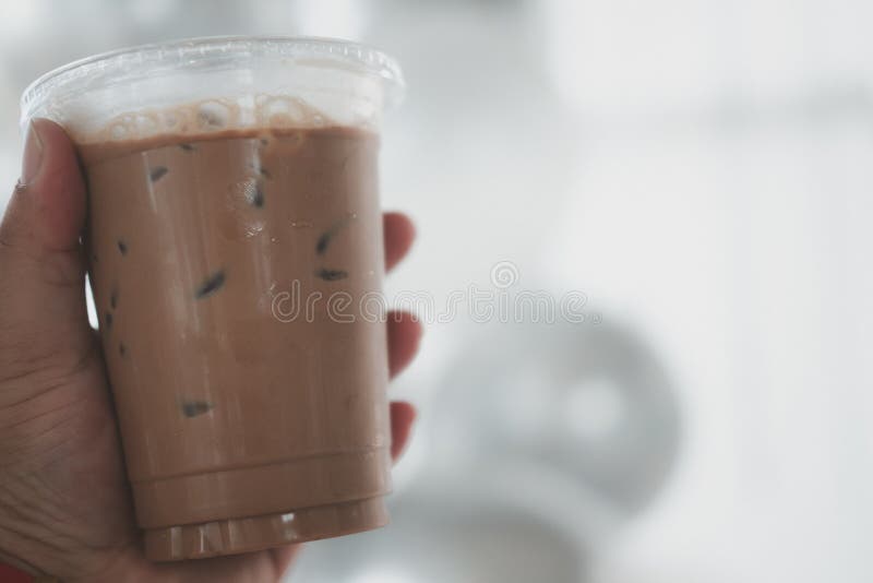 Iced Mocha Coffee in Clear Plastic Cup on Hand Stock Photo - Image of ...