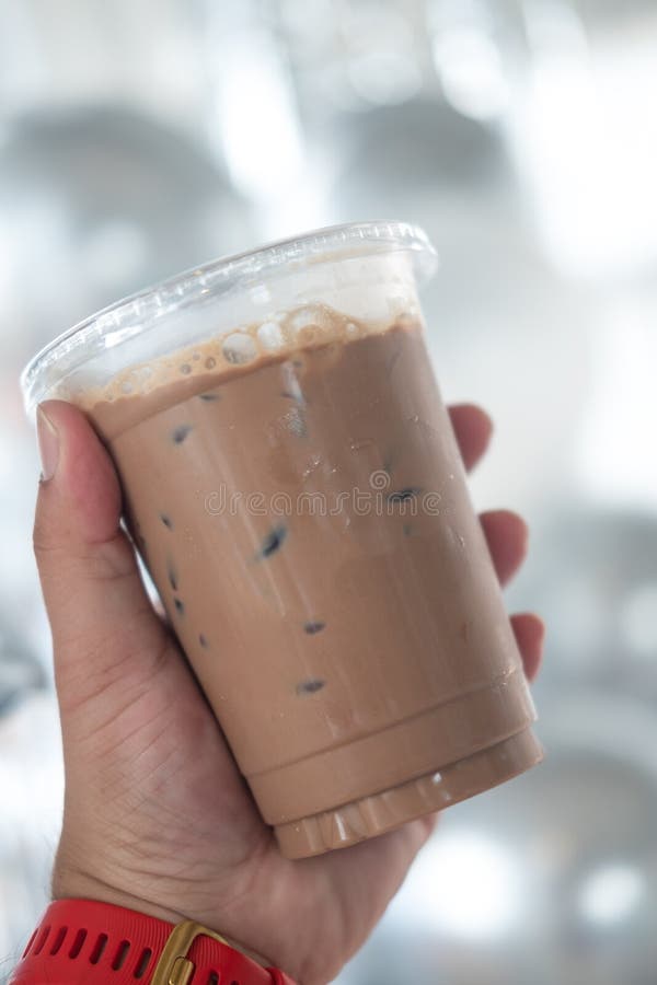 Iced Mocha Coffee in Clear Plastic Cup on Hand Stock Image - Image of ...