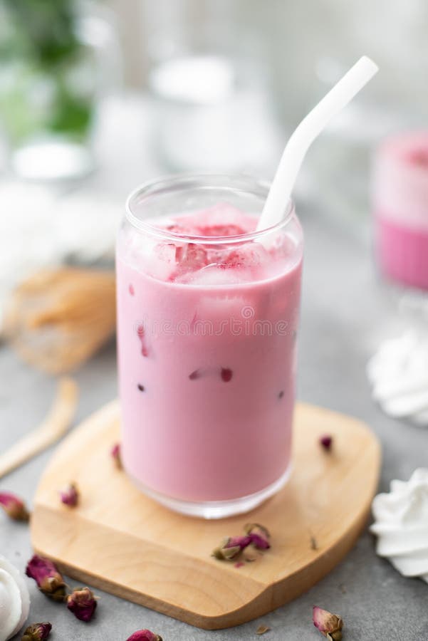Iced Pink Milk in a Clear Plastic Cup with Brown Color Plastic Tubes on ...