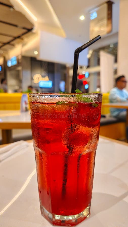 Iced Red Fruit Drink with Straw and Mint in a Glass Stock Image - Image ...
