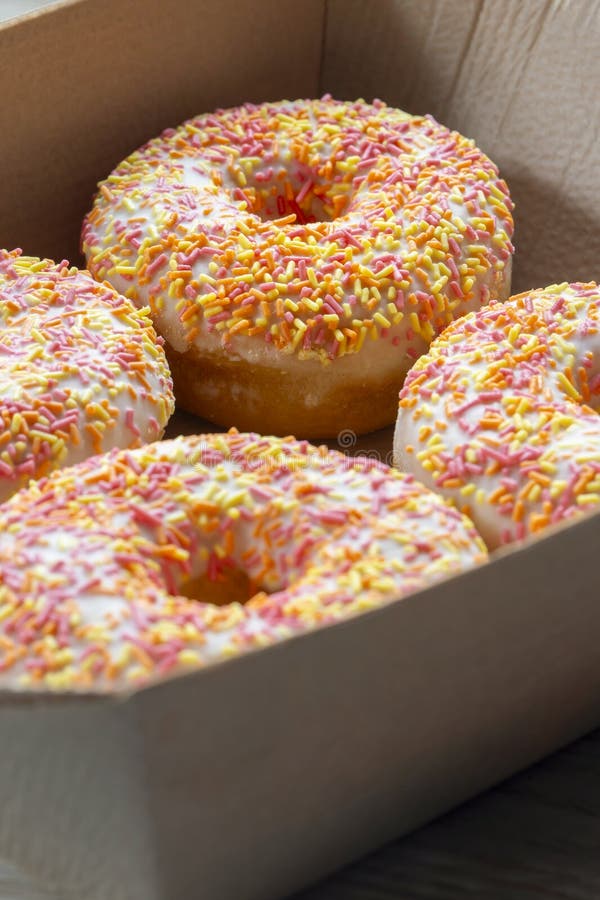 Iced Ring Doughnuts Sprinkled with Hundreds and Thousands in a Card ...
